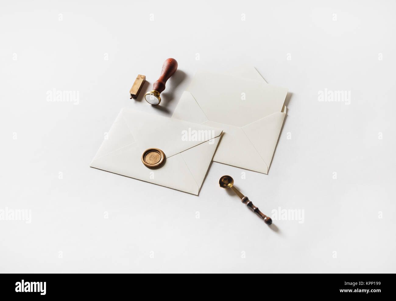 Letter envelope with golden wax seal, stamp, spoon and postcard on ...