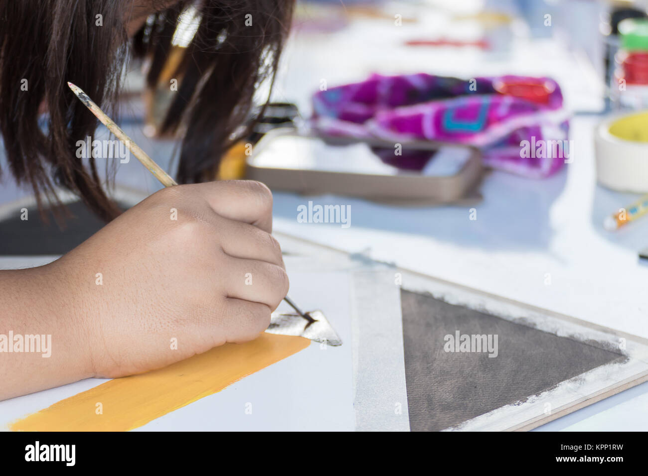 Hand with brush and paint by watercolors Stock Photo - Alamy