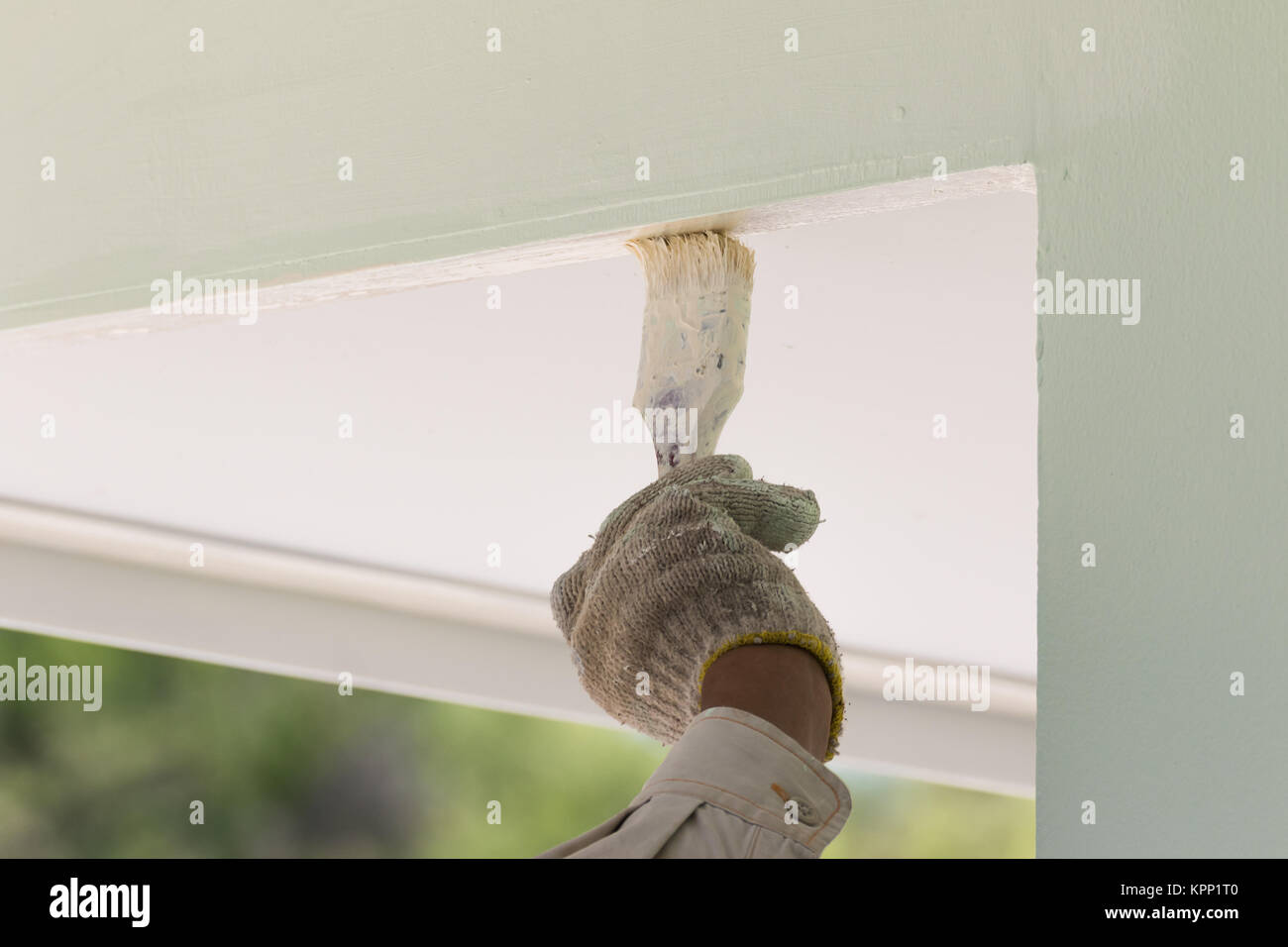 Hand with paintbrush painting Stock Photo - Alamy