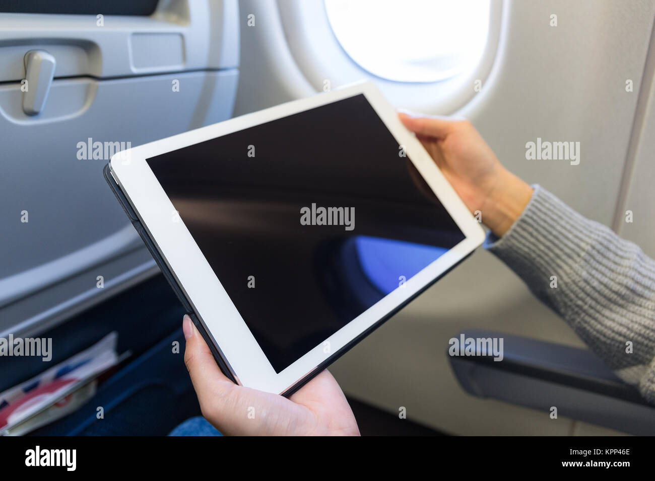 Woman use of digital tablet at airplane Stock Photo - Alamy