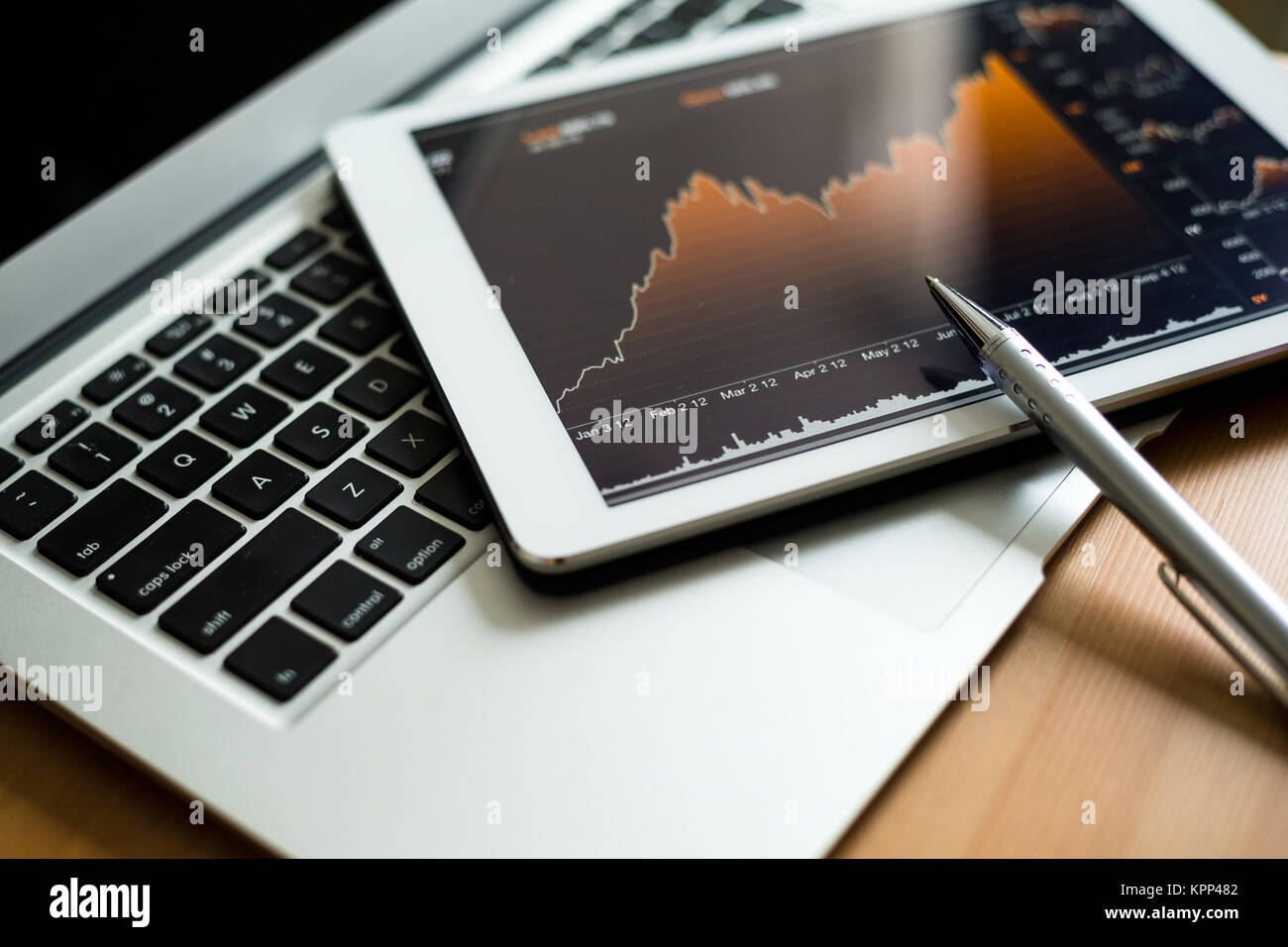 Workplace with digital tablet showing chart and diagram Stock Photo - Alamy