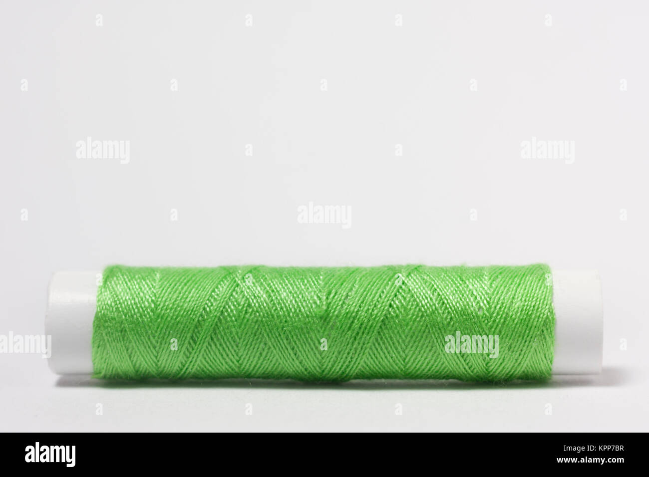 Spools of sewing thread isolated on gray Stock Photo - Alamy