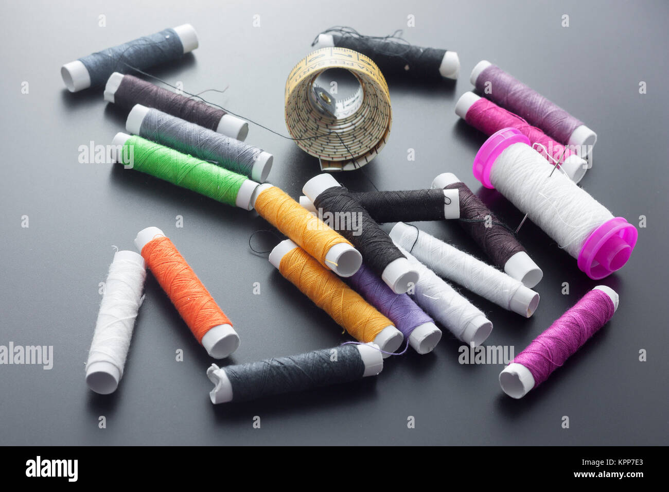 Spools of sewing thread isolated on gray Stock Photo - Alamy