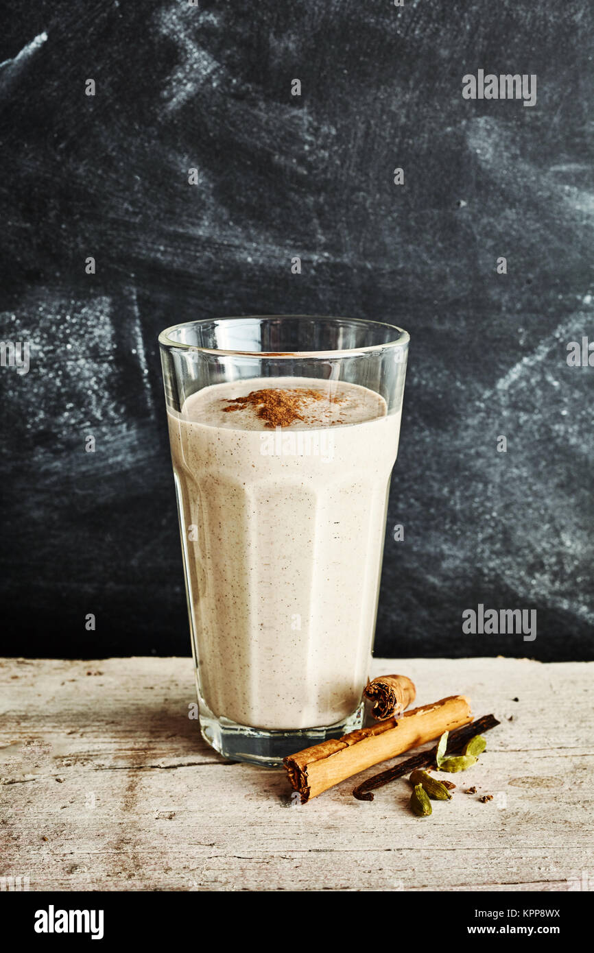 Large glass of delicious chai latte with a sprinkle of cinnamon on a ...