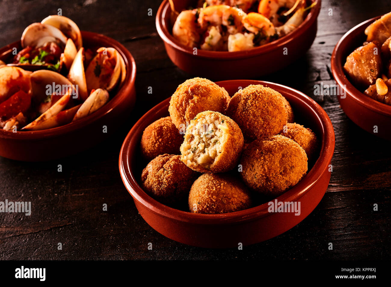 Bowl full of fried round croquettes with delicious stuffing beside ...