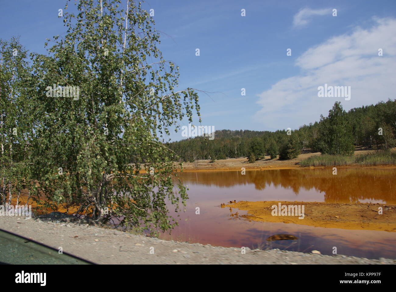 Very dirty river with orange water Stock Photo - Alamy