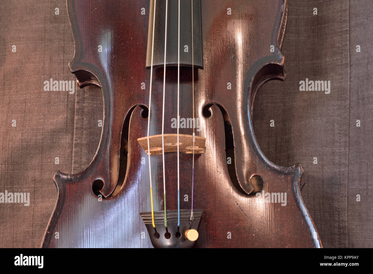 Antique violin closeup against gray fabric background Stock Photo - Alamy