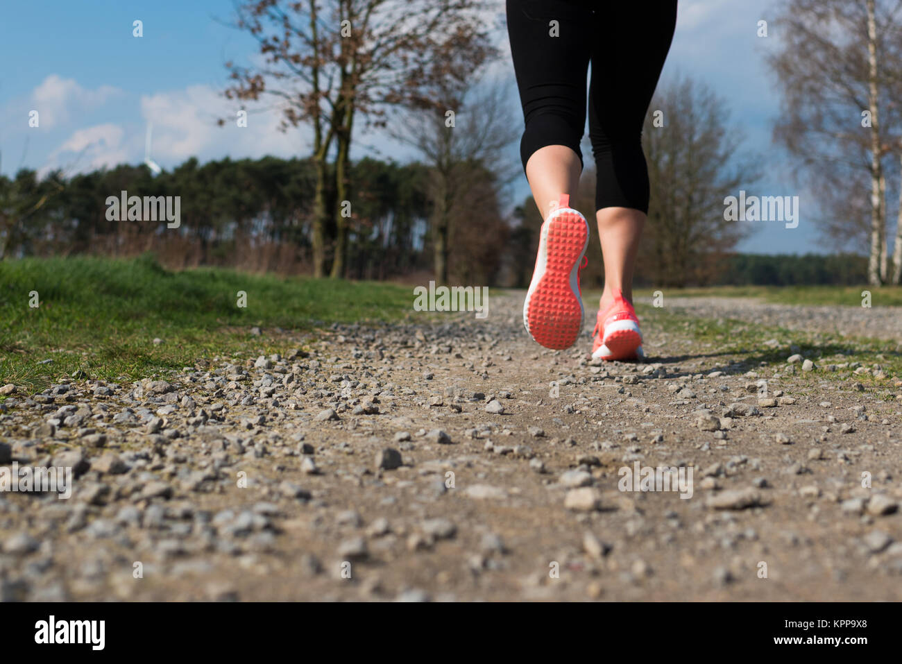 jogger running on a dirt road in the spring Stock Photo - Alamy