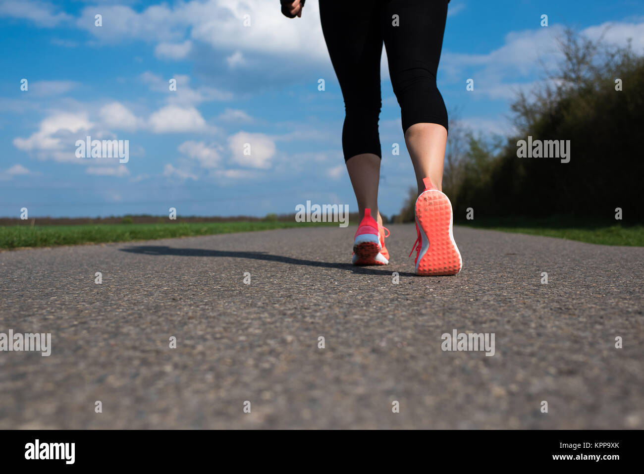 Jogger walks on a street in spring Stock Photo - Alamy