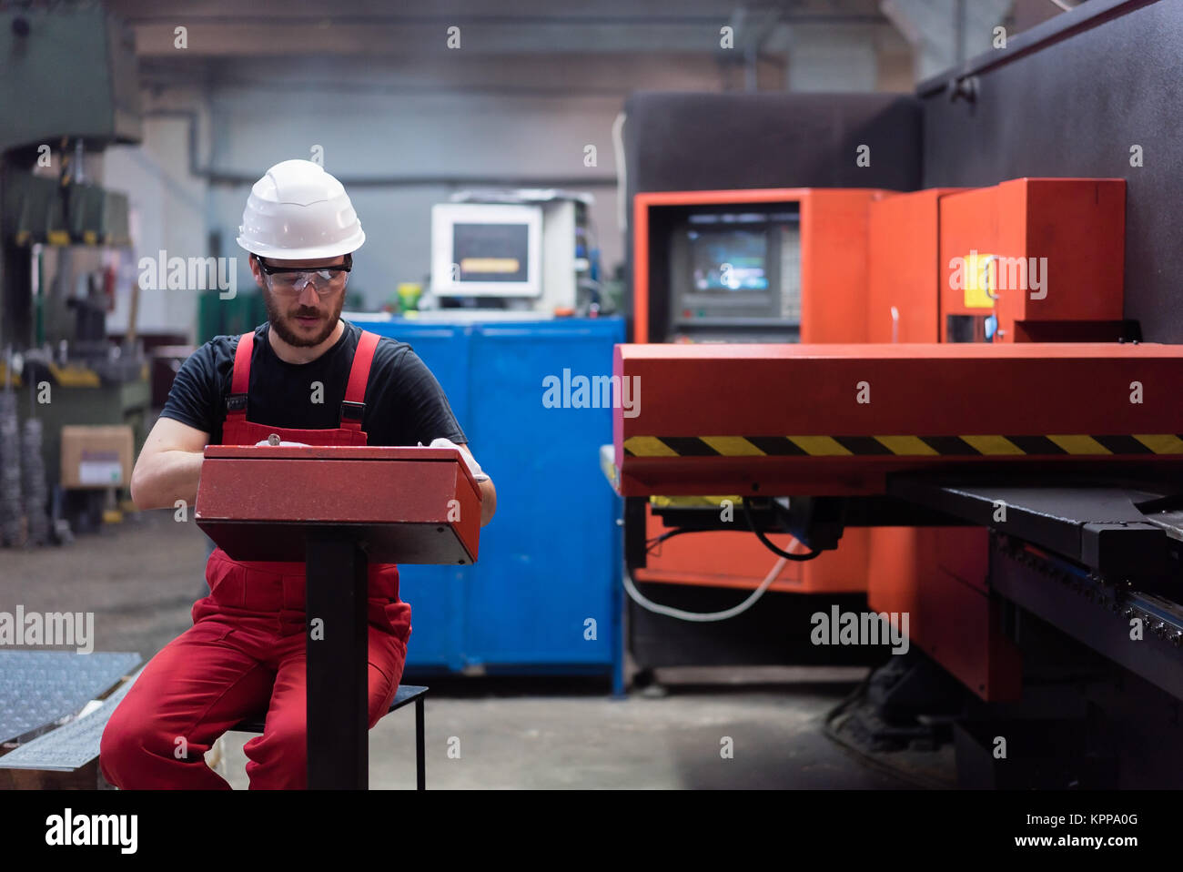 operating a red-painted heavy-duty machinery Stock Photo - Alamy