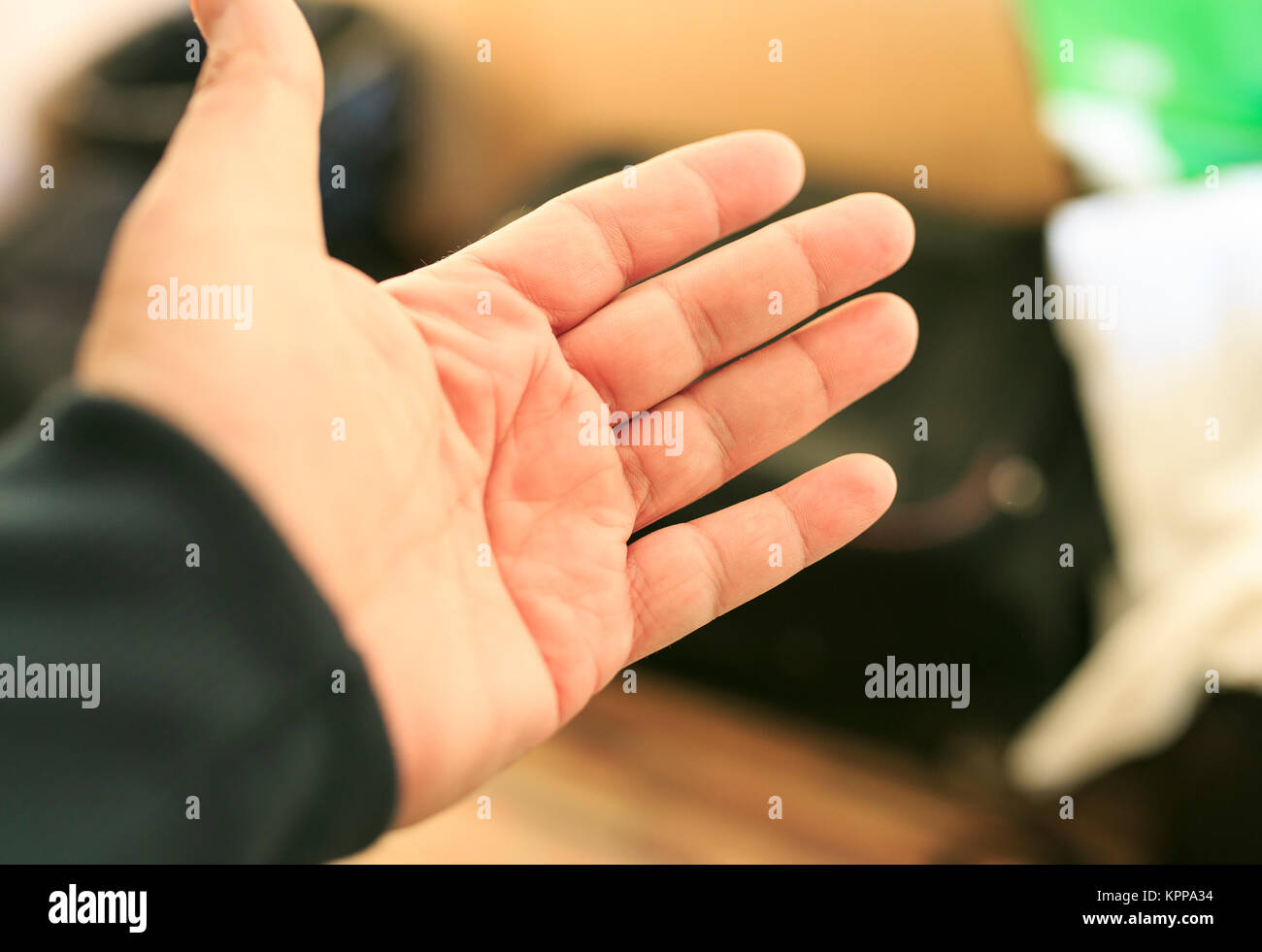 Hand waiting other hand to salute Stock Photo - Alamy