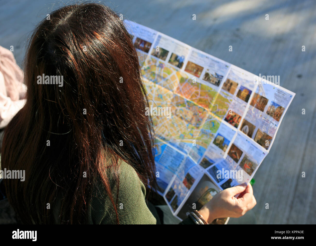 Girl looking a map in the street Stock Photo - Alamy