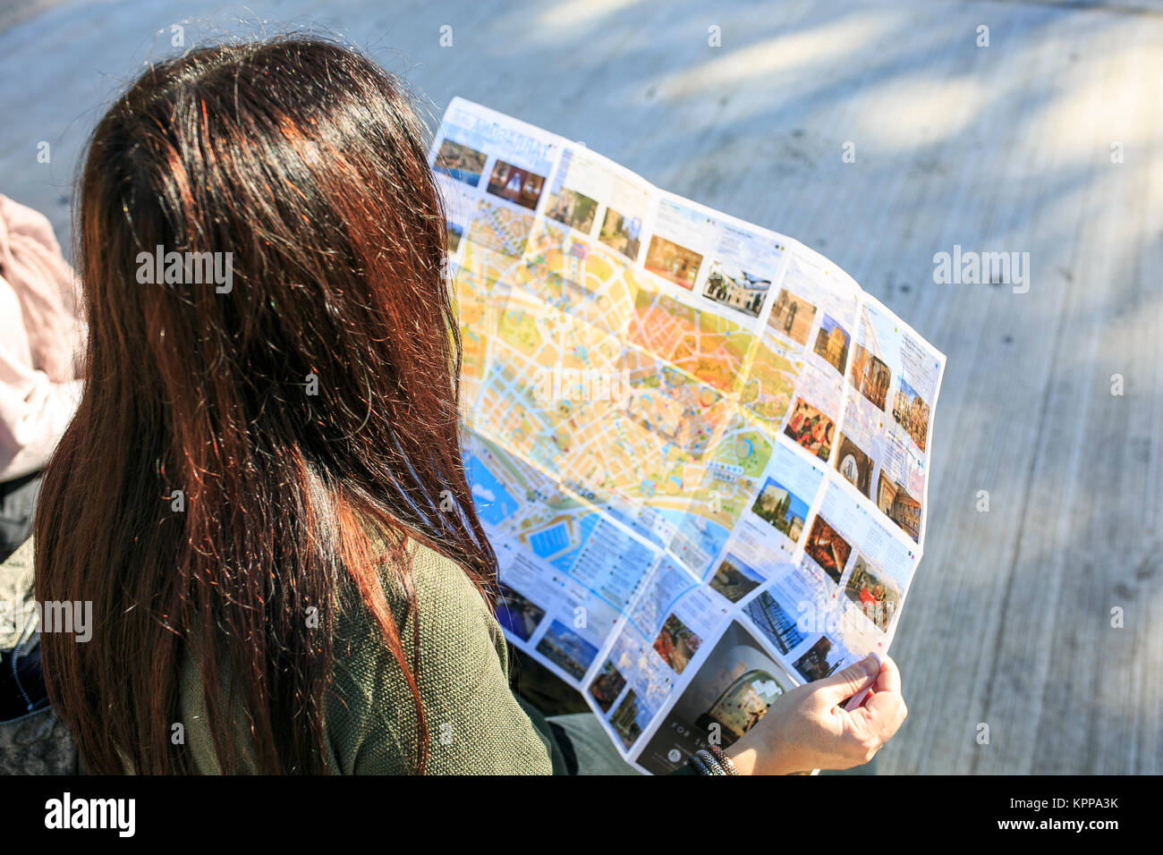 Girl looking a map in the street Stock Photo - Alamy