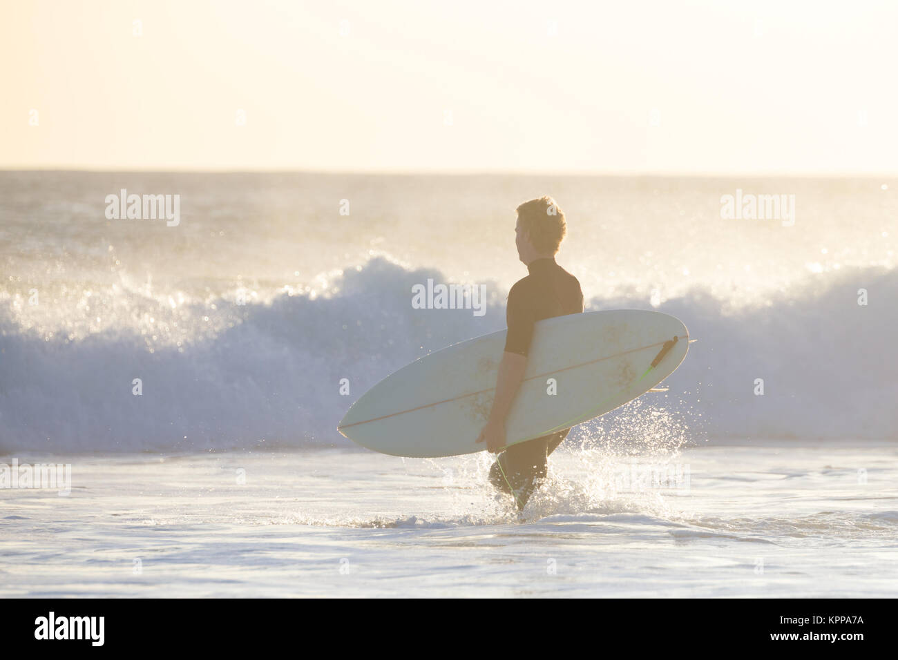 Surfers on beach with surfboard Stock Photo - Alamy