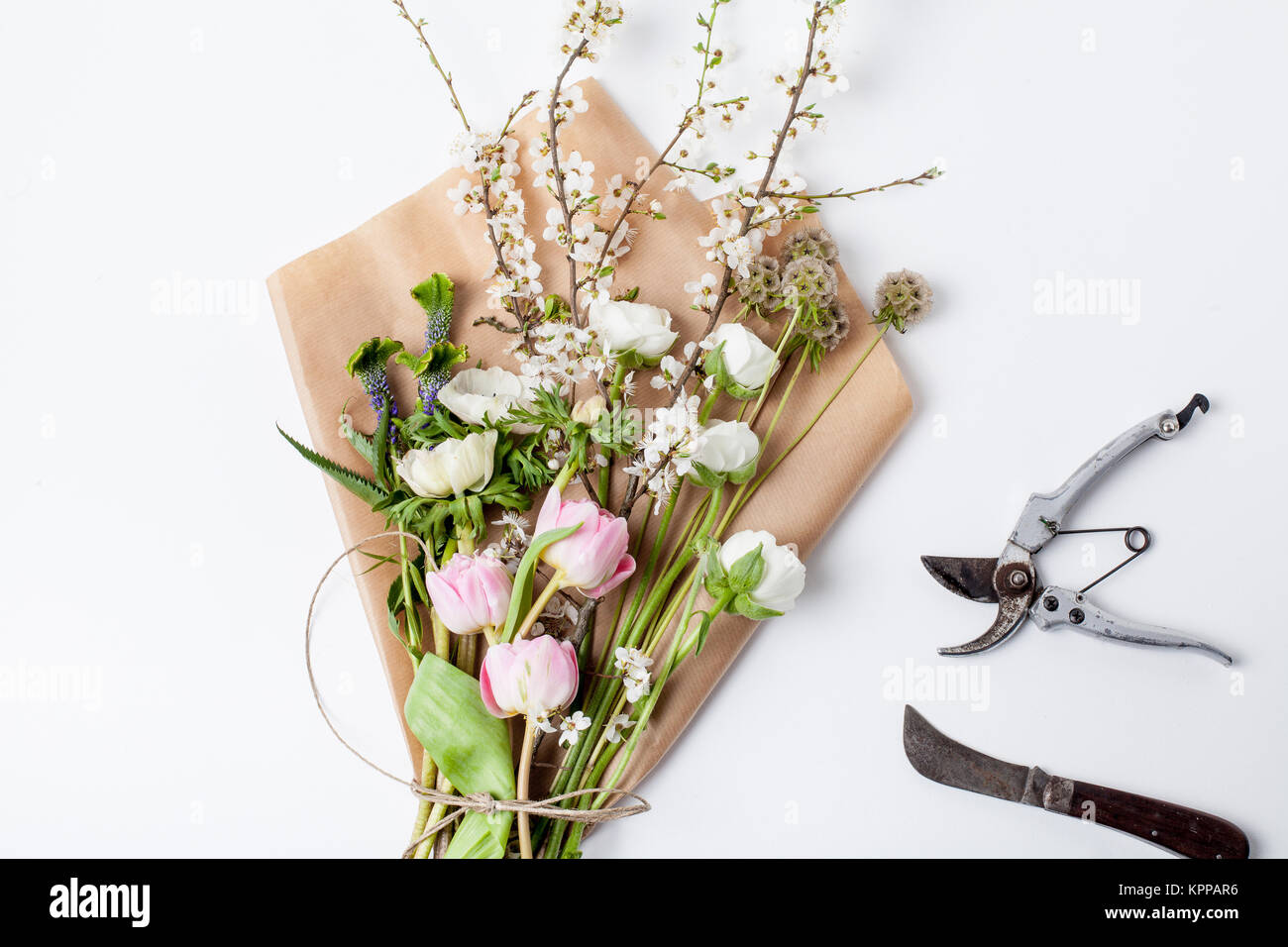 Bunch of spring flowers on wrapping paper with implements Stock Photo ...