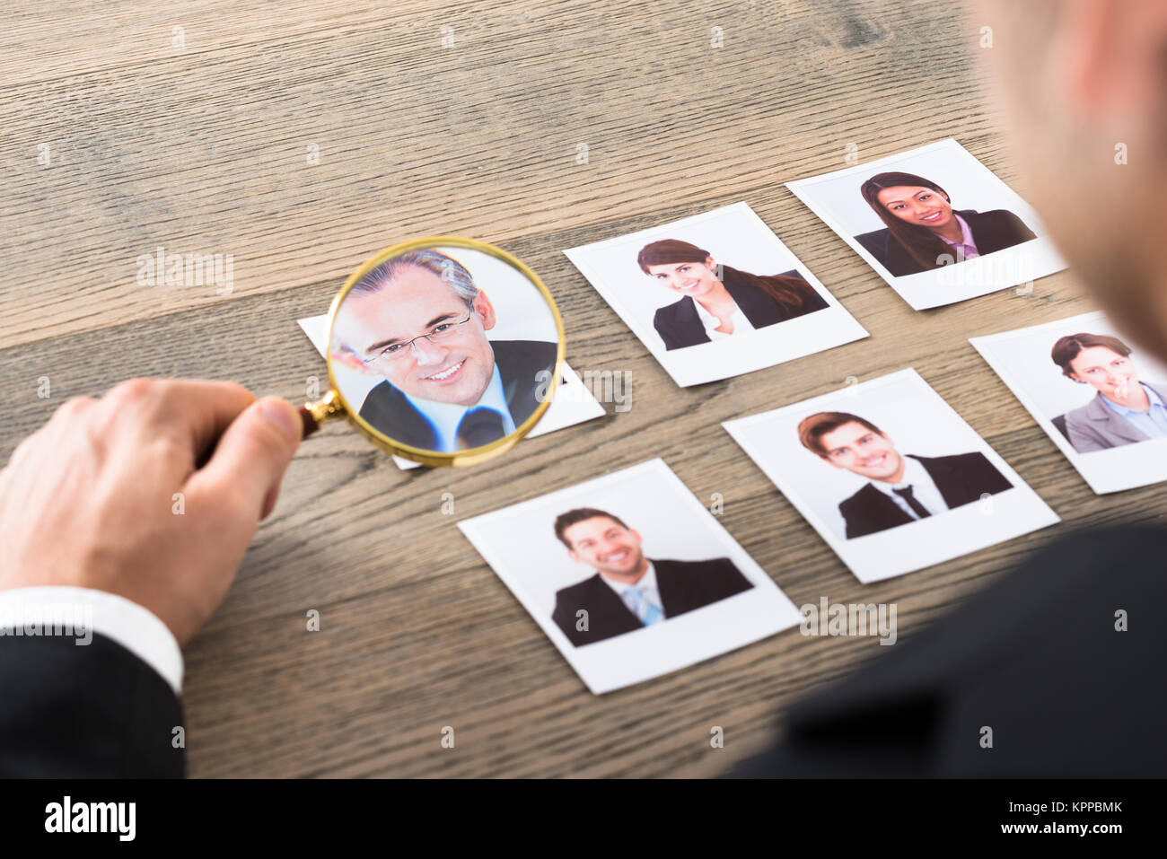 Businessman Viewing Candidates Through Magnifying Glass Stock Photo - Alamy
