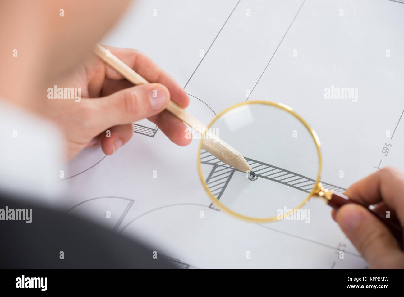 Architect Working With Magnifying Glass Stock Photo - Alamy