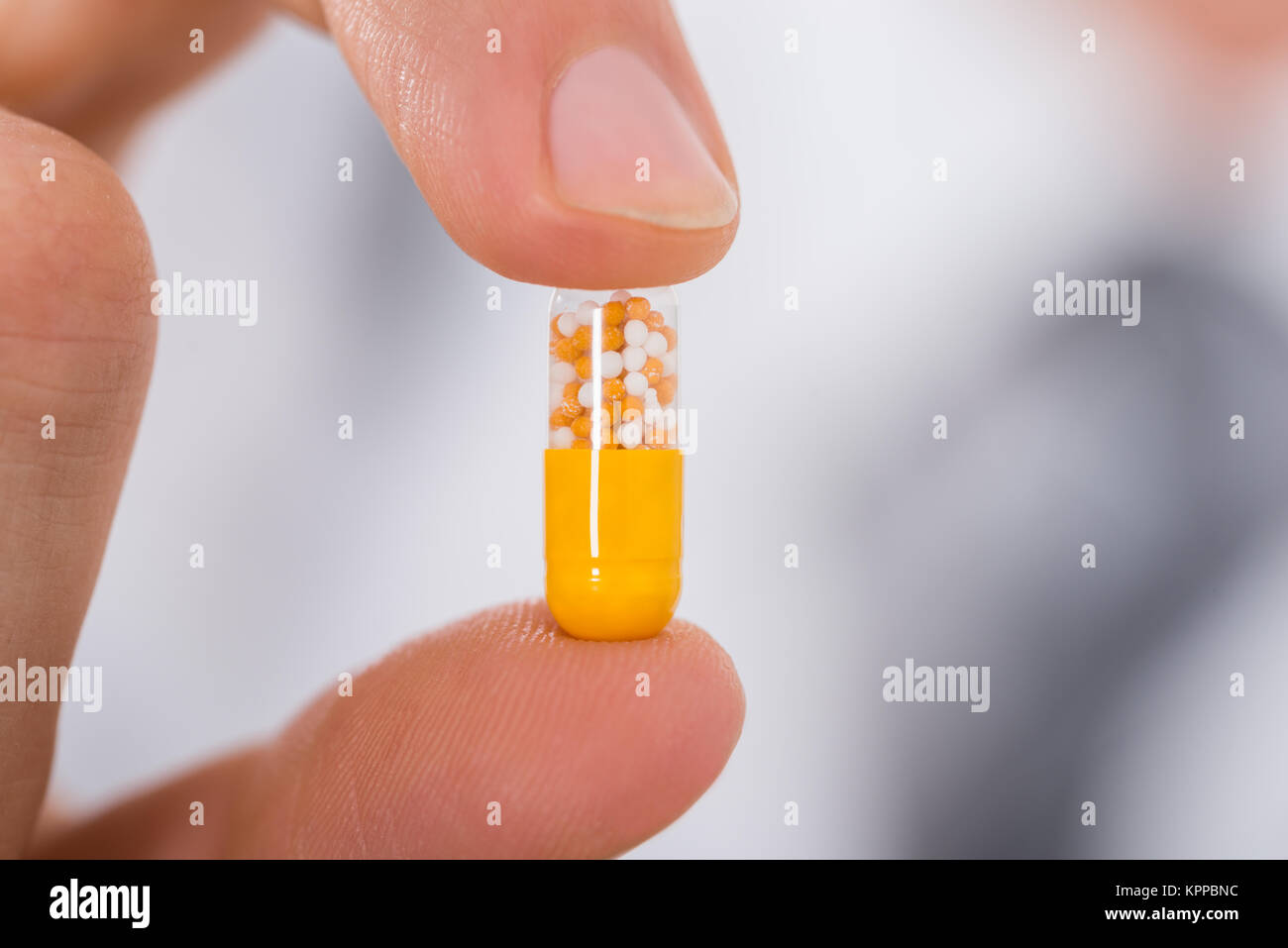 Male Doctor Holding Capsule Stock Photo - Alamy