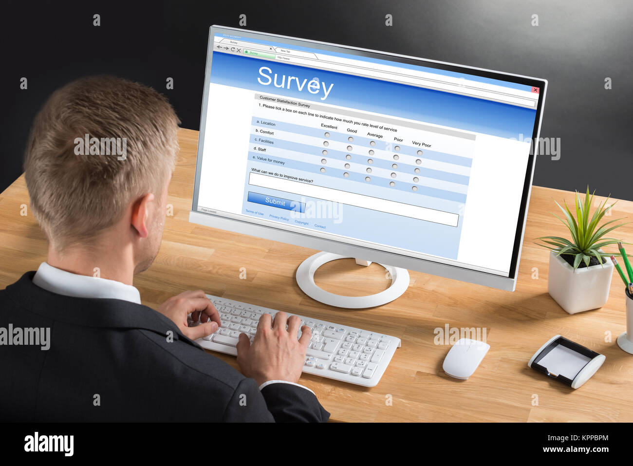 Businessman Filling Online Survey Form On Computer Stock Photo - Alamy