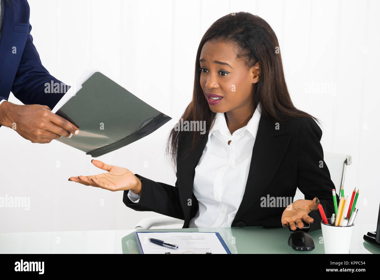 Boss Showing Document To Her Female Executive Stock Photo - Alamy