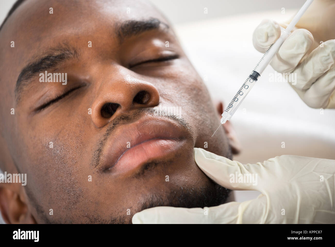 Person Hand Injecting Syringe On Young Man Face Stock Photo - Alamy