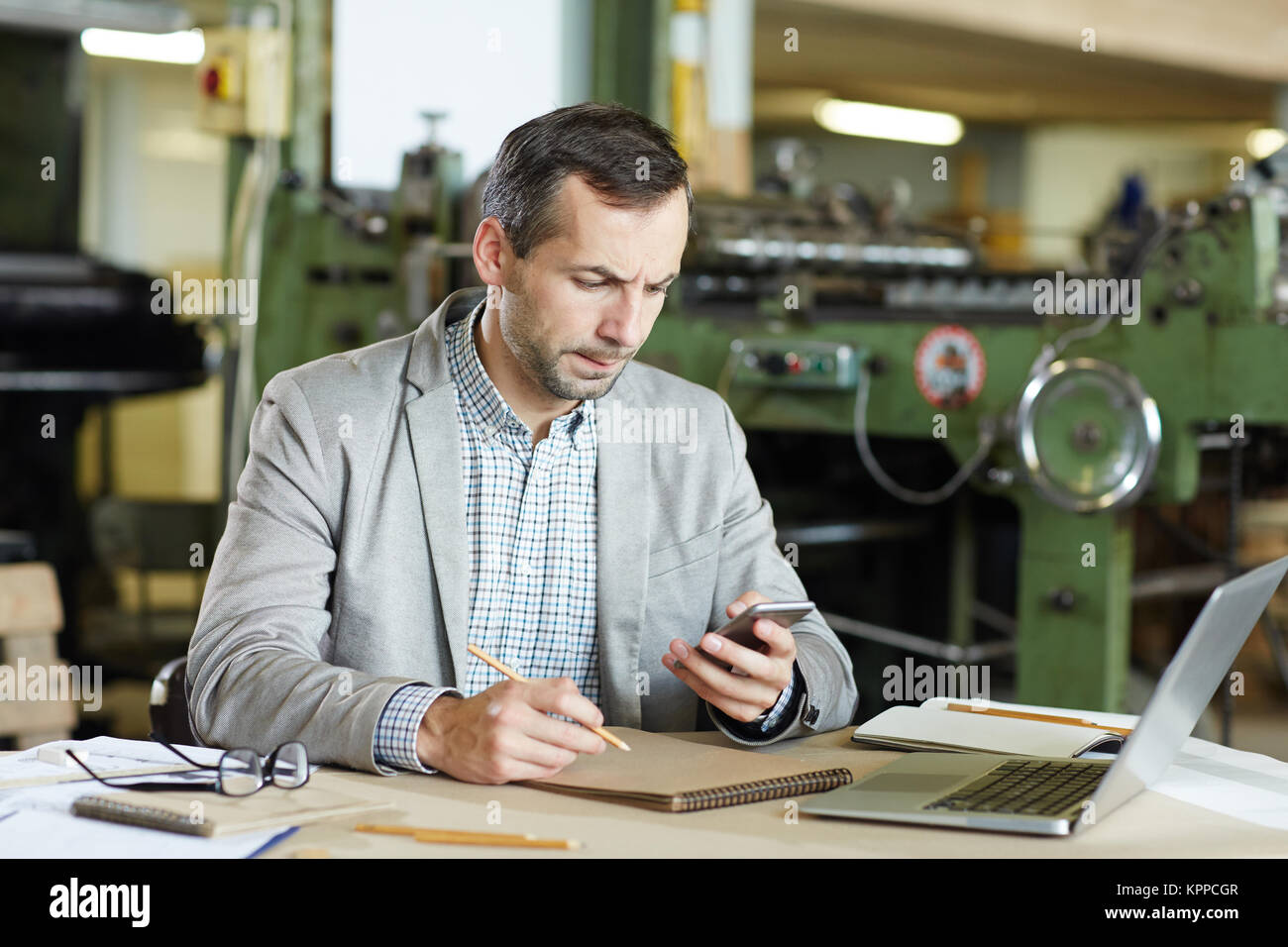 Sketching and texting Stock Photo - Alamy