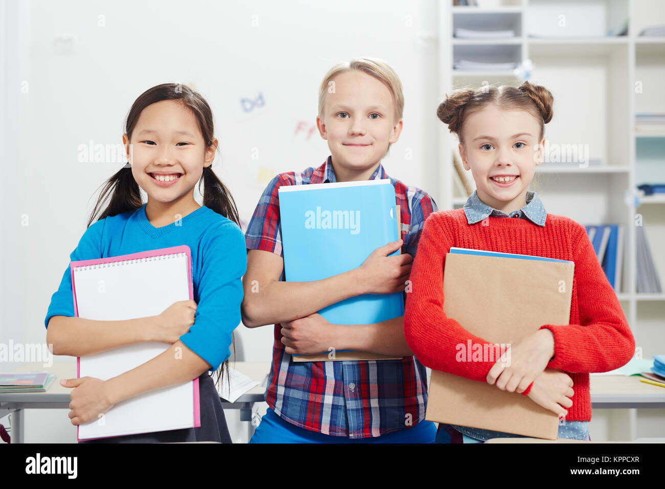 Kids with notepads Stock Photo - Alamy