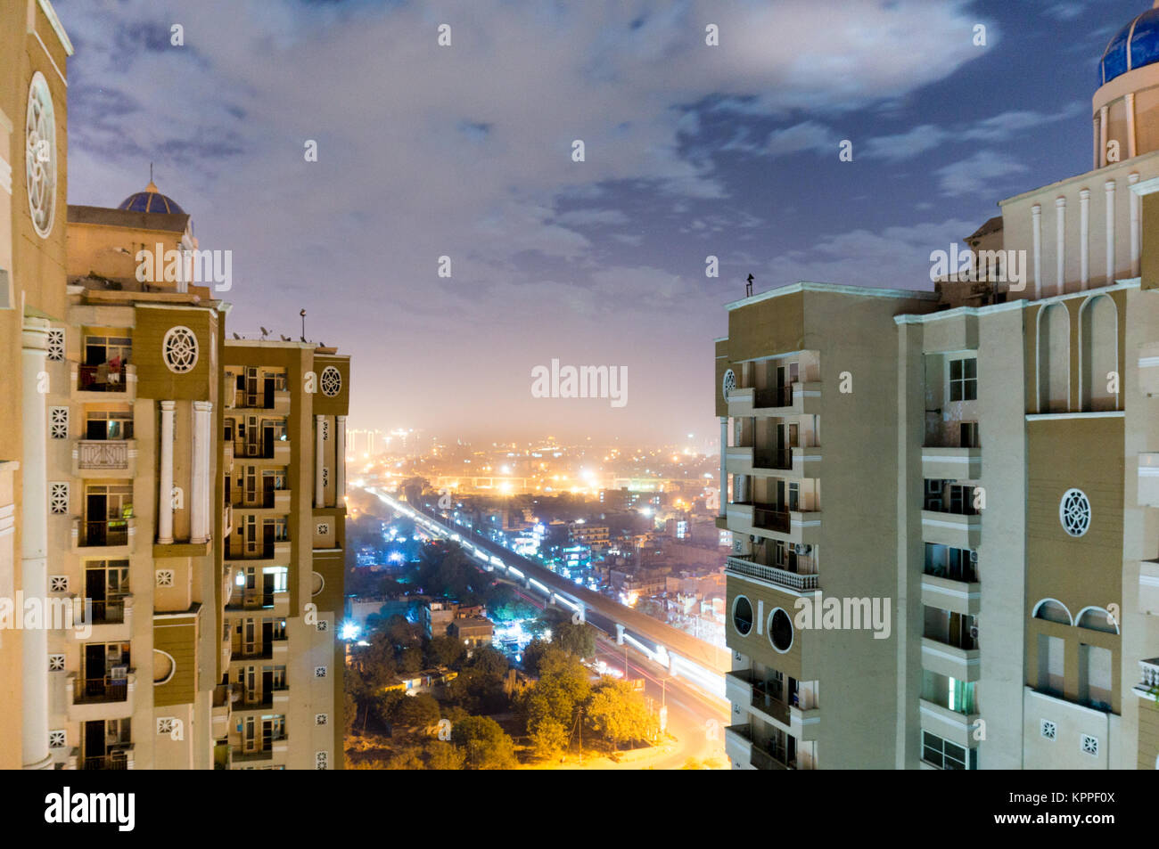 Skyscrapers shot on a cloudy night with the noida delhi cityscape ...