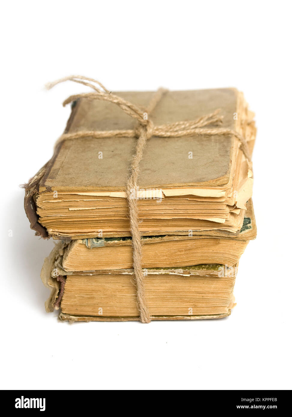 a stack of shabby old books tied with string on white background Stock ...
