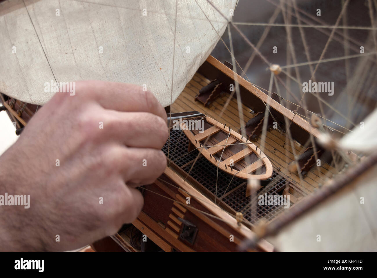 Young man constructing a ship model in a ship-modelling studio Stock ...