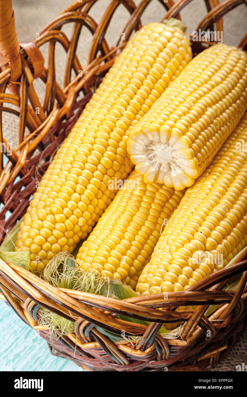 Basket of fresh sweetcorn, husked Stock Photo - Alamy