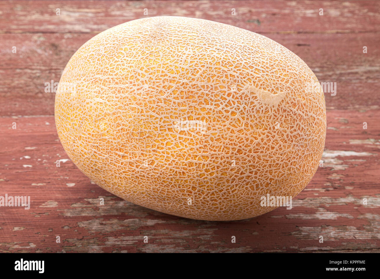 a whole ripe melon on a dark brown table Stock Photo - Alamy