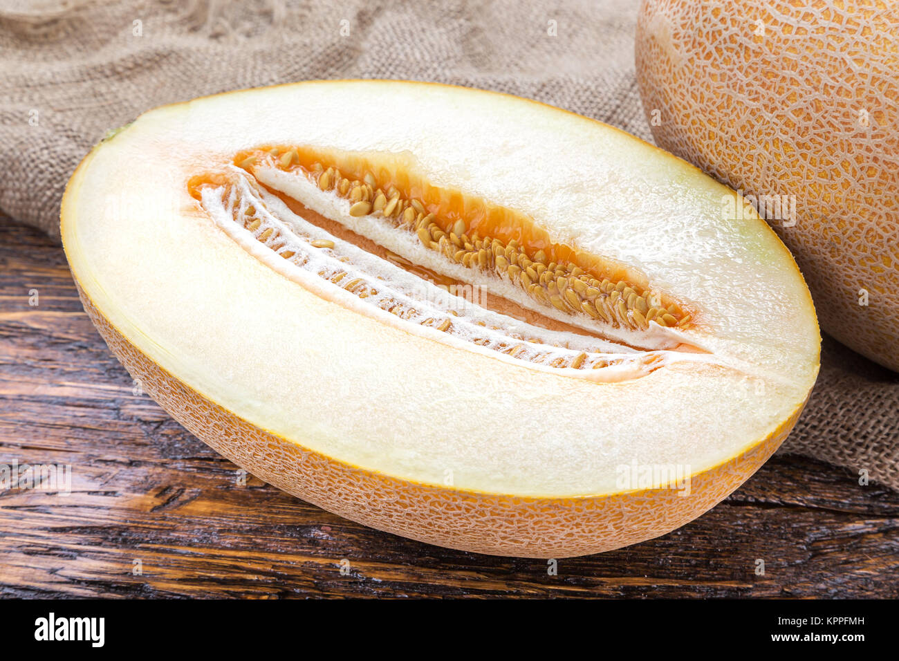 juicy ripe cut melon on a dark brown table Stock Photo - Alamy