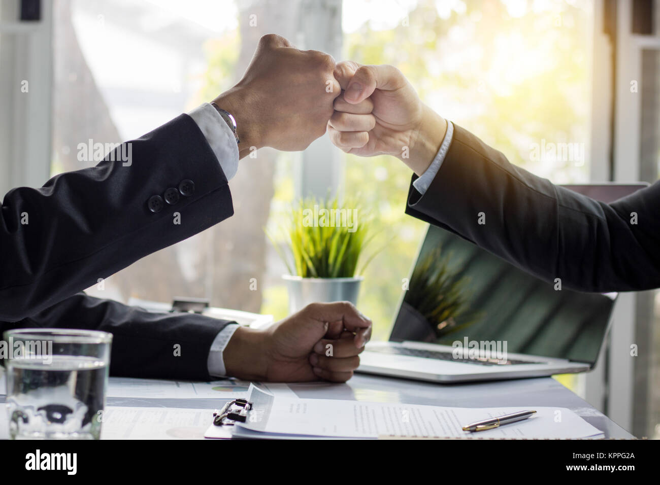 group of man punch in office, teamwork concept Stock Photo - Alamy