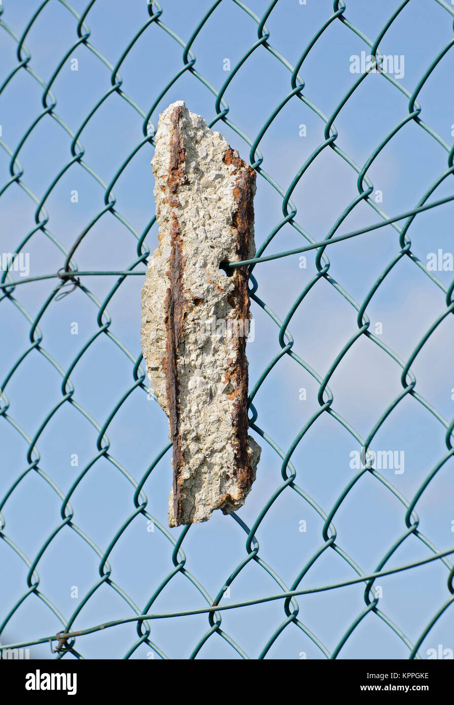 Crumbling concrete post being supported by chain link fence it was ...