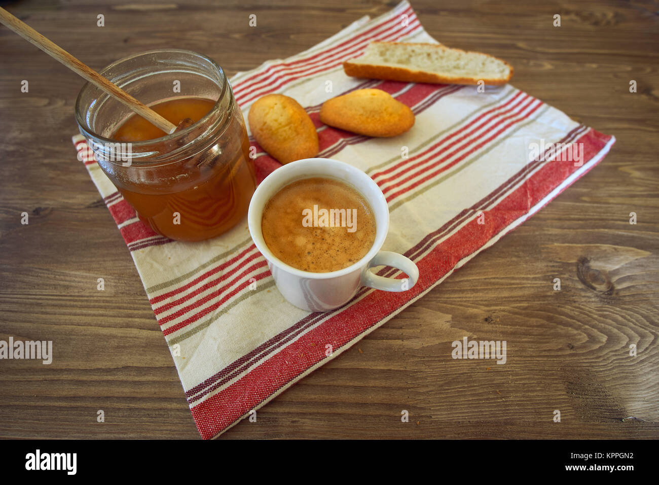 Sweet breakfast table with coffee, bread, honey jar, cake and fruits ...