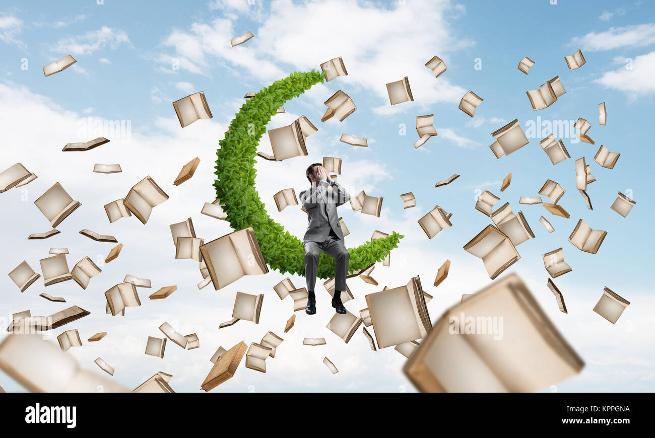 Young man in sky do not want to see anything and books flying around ...