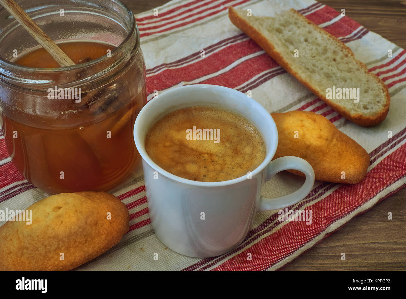 Sweet breakfast table with coffee, bread, honey jar, cake and fruits ...