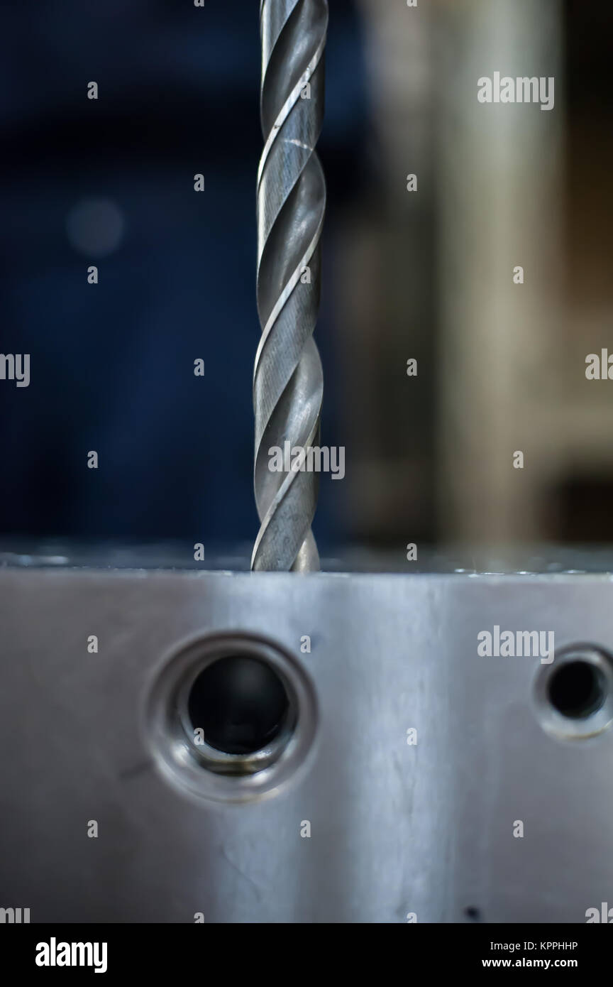 Large and powerful automatic heavy industrial drill bit cutting the ...