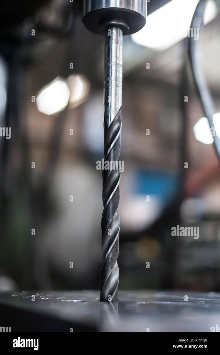 Large and powerful automatic heavy industrial drill bit cutting the ...