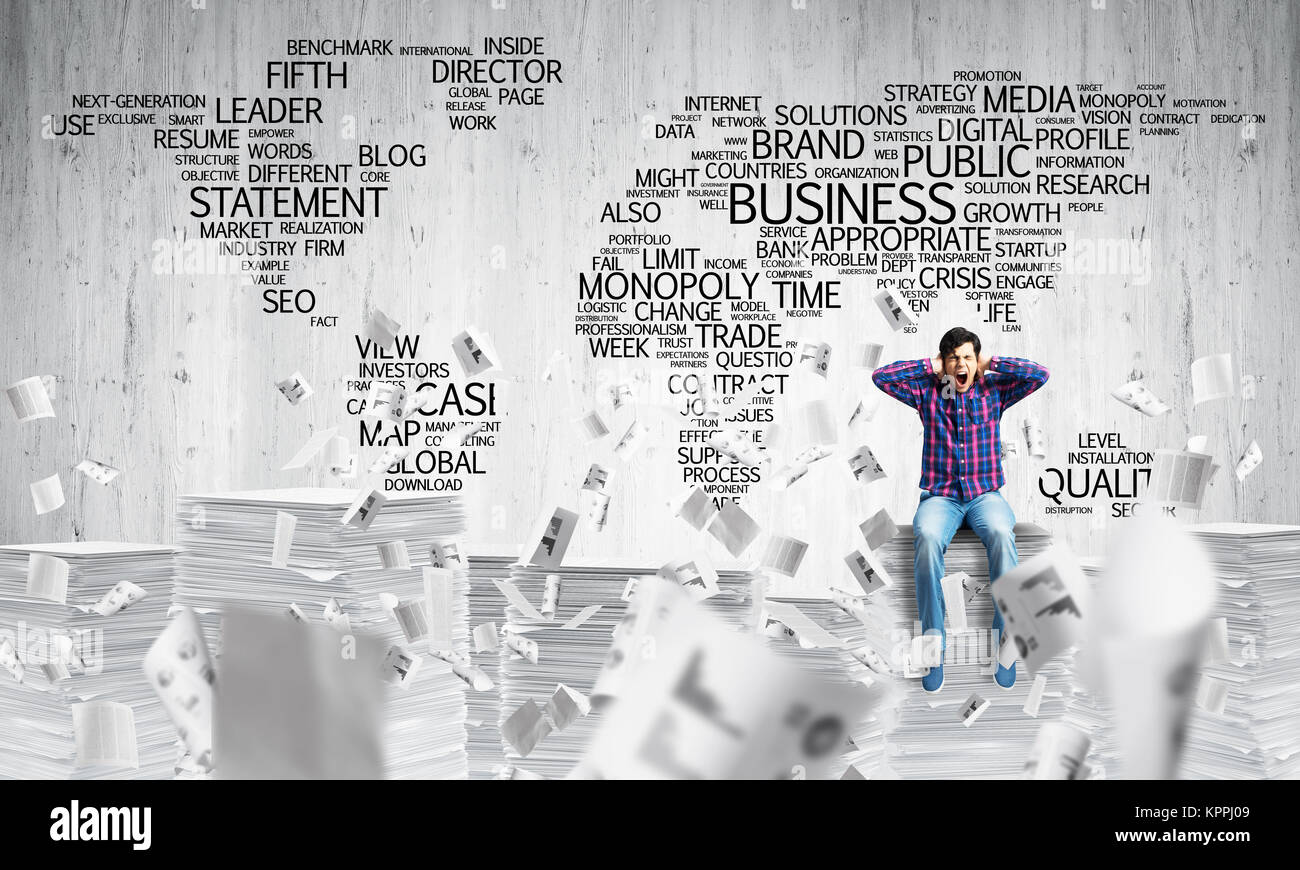 Attractive man sitting on pile of paper documents Stock Photo - Alamy