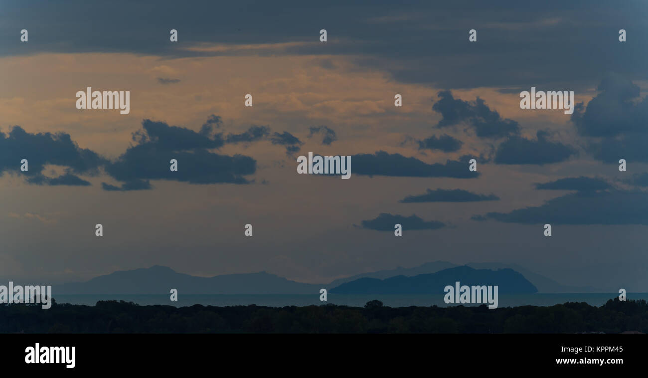 far out sunset island with clouds Stock Photo - Alamy