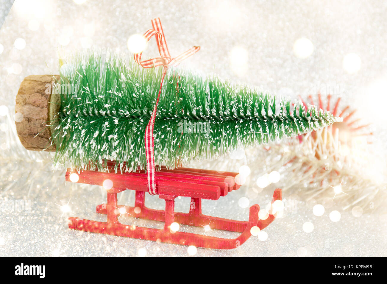 miniature fir tree tied to red sleds Stock Photo - Alamy