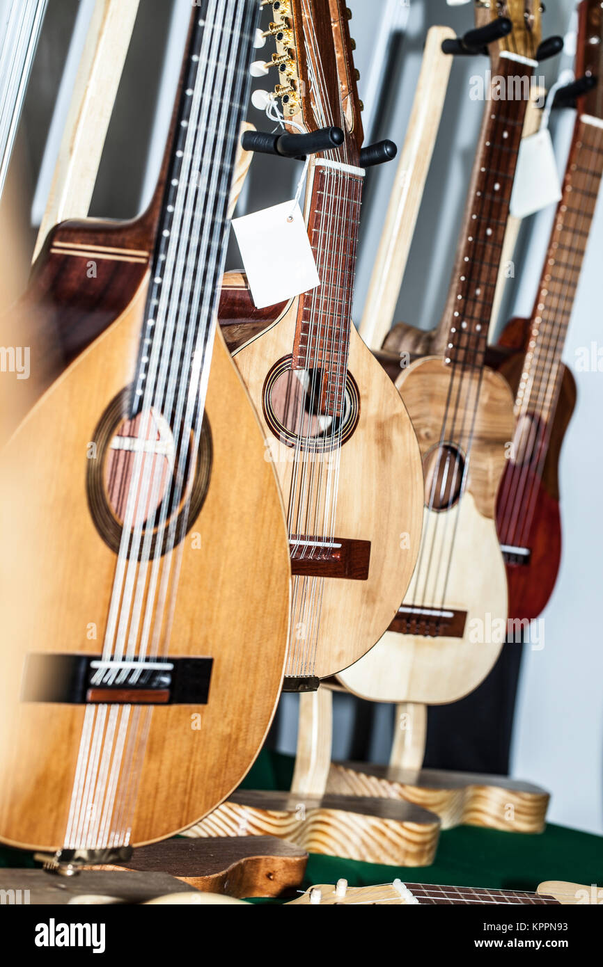 TIMPLE INSTRUMENTS for sale hanging in a music shop Stock Photo - Alamy