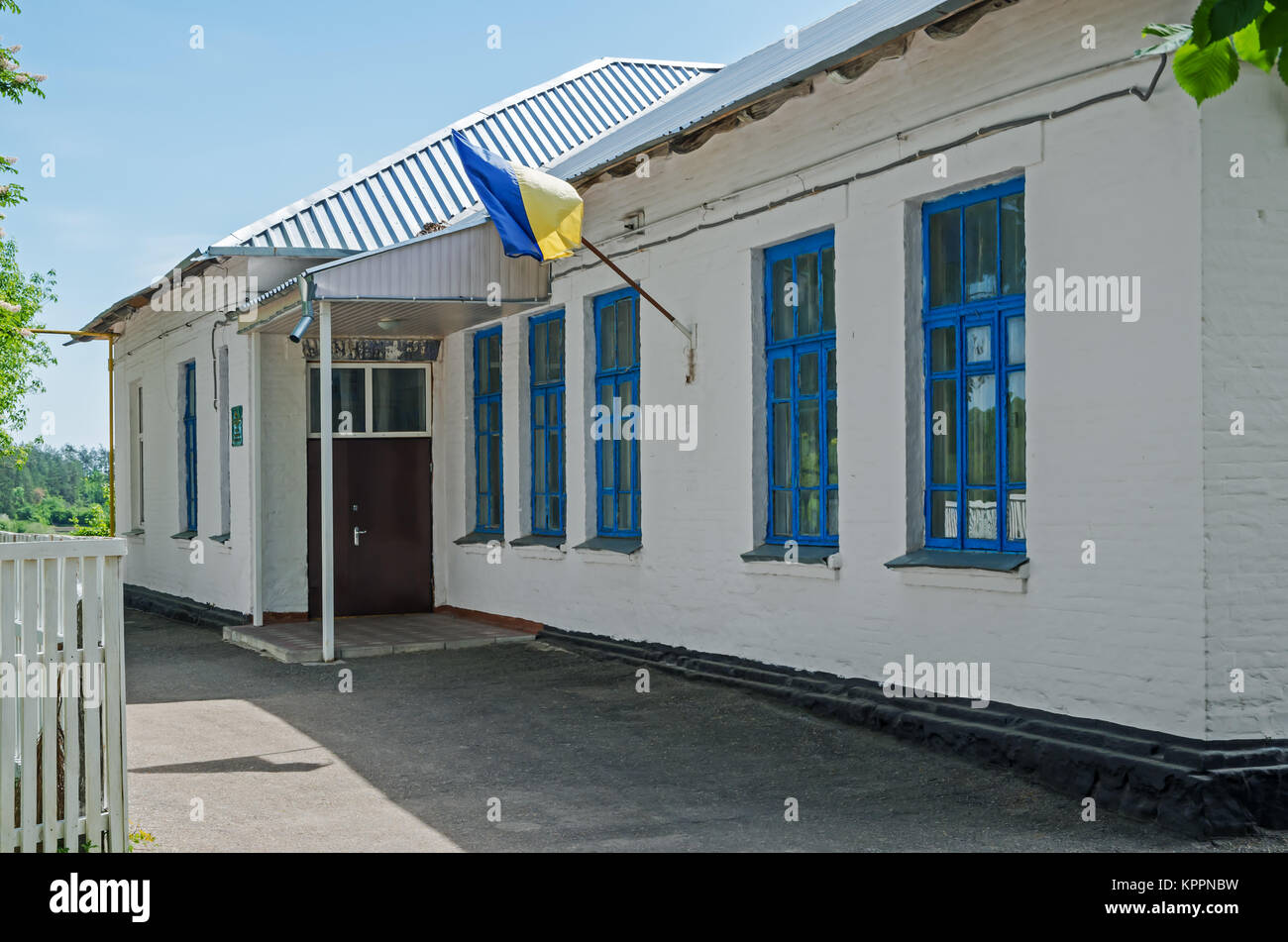 Facade of a one-story old rural school in the middle of spring Stock ...
