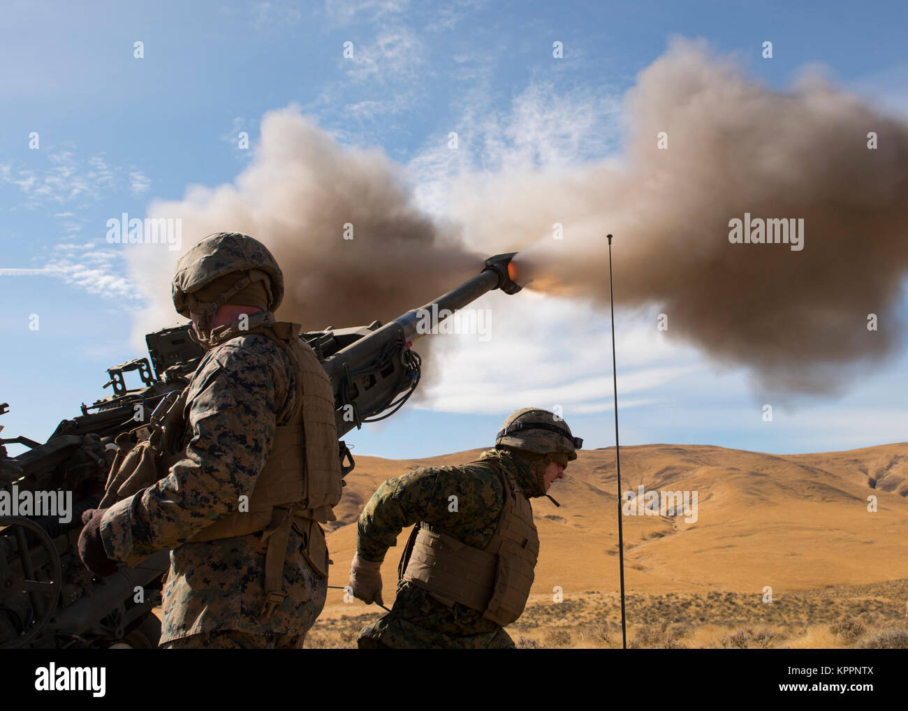 Marines of P Battery 5/14 fire a high explosive projectile downrange ...