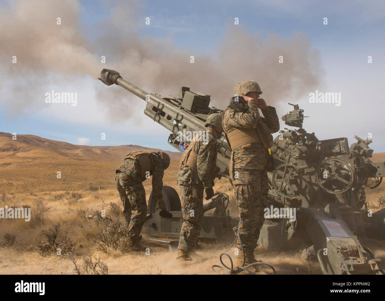 Marines of P Battery 5/14 fire a high explosive projectile downrange ...