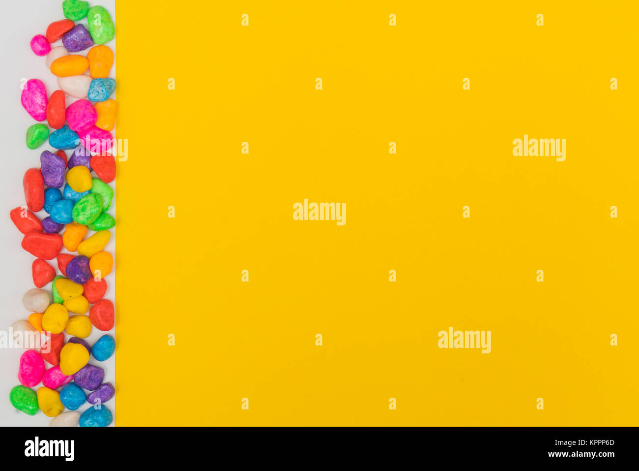 small colored pebbles on a white background Stock Photo - Alamy