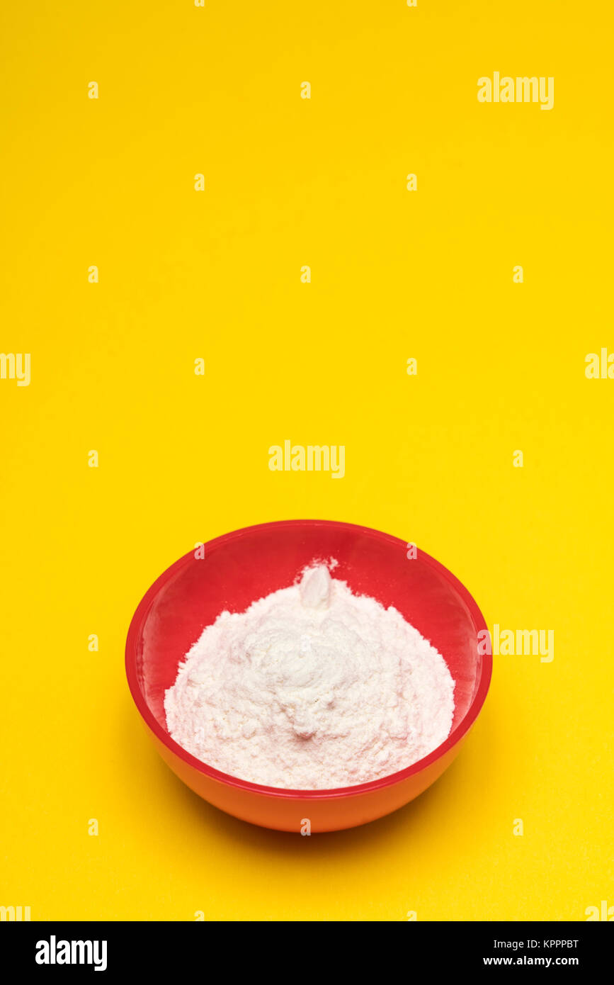 flour in a bowl on a colored background Stock Photo - Alamy