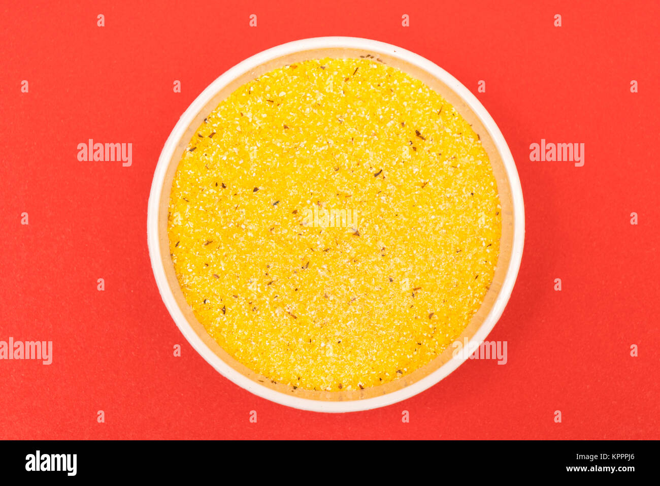 cornmeal a bowl on a colored background Stock Photo - Alamy